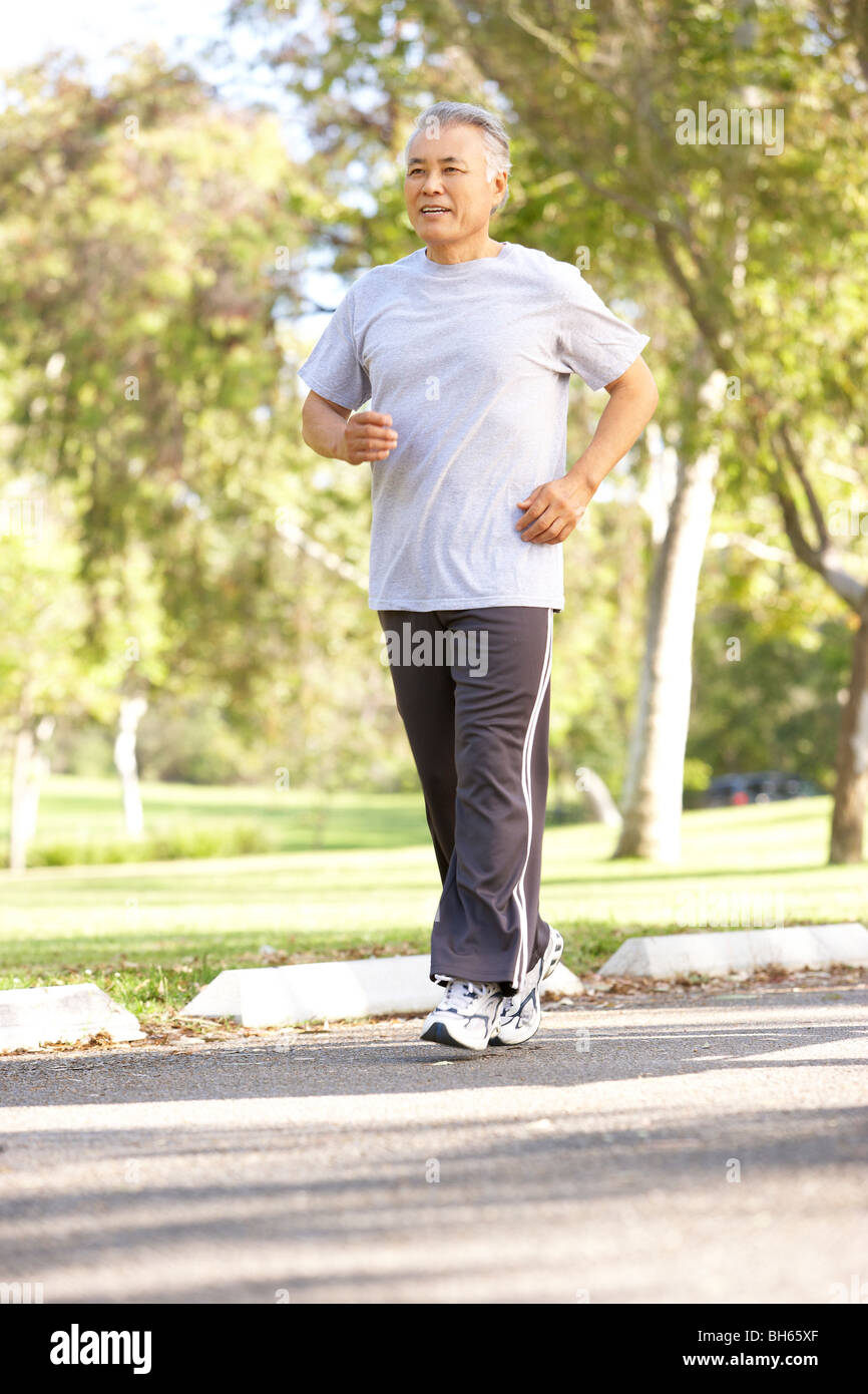 Senior Man Jogging In Park Stock Photo - Alamy
