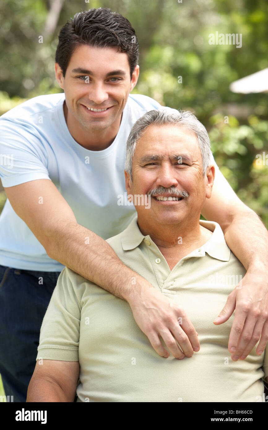 Senior Man With Adult Son In Garden Stock Photo - Alamy