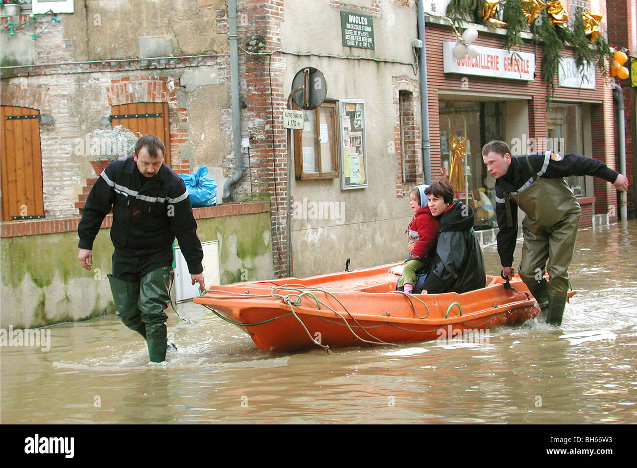 FIREFIGHTERS EVACUATING PEOPLE DURING THE FLOODING OF THE TOWN CENTER ...