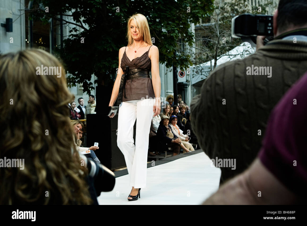 A female model parades her garments while walking the cat walk during ...