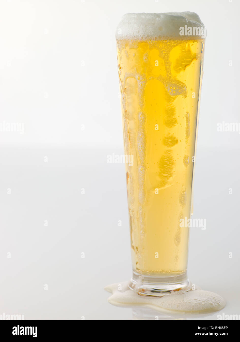 Glass Of Frothy Beer Stock Photo - Alamy