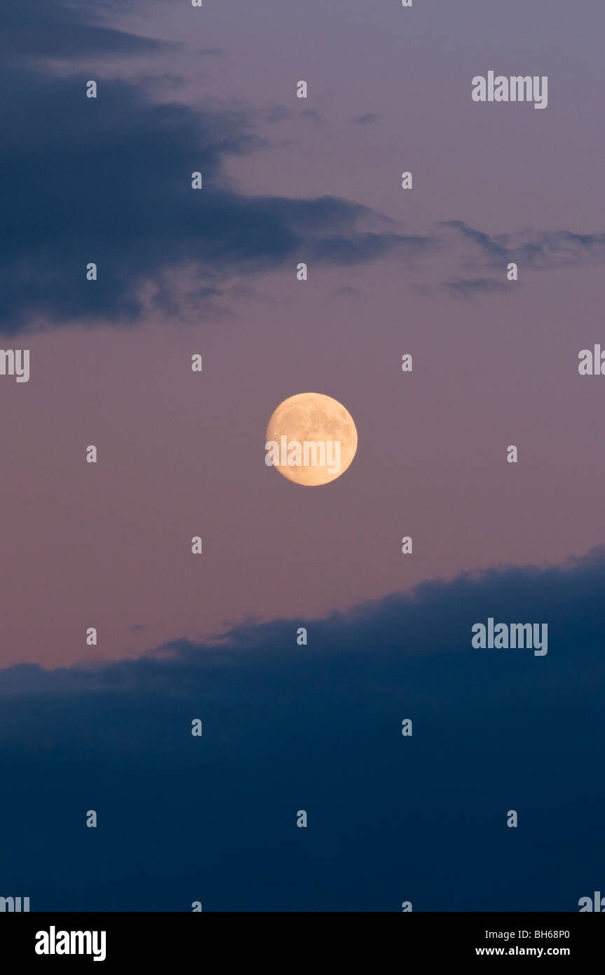Moon and colorful clouds at sunset Stock Photo - Alamy