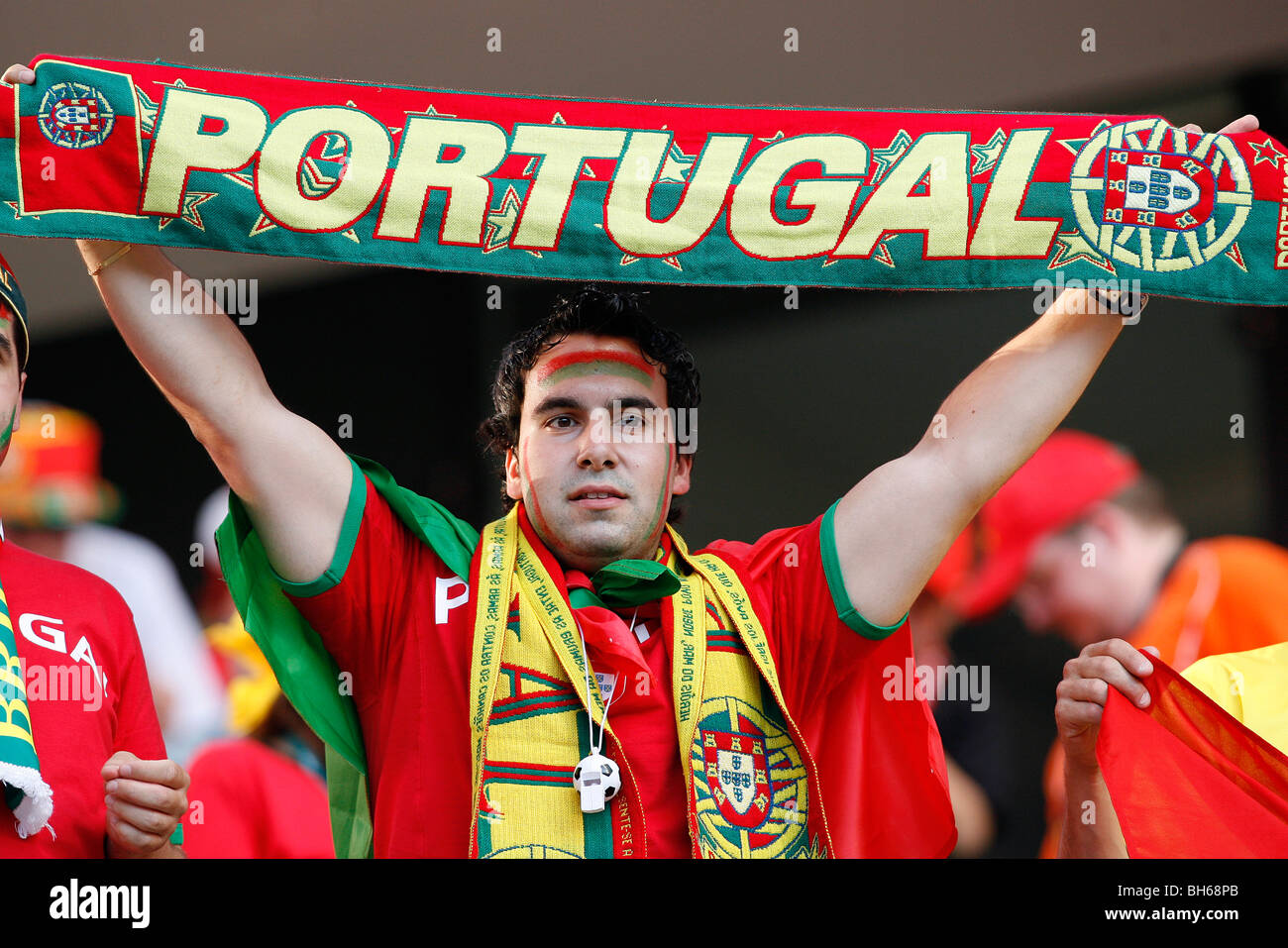 Football supporter holds up scarf hi-res stock photography and images ...