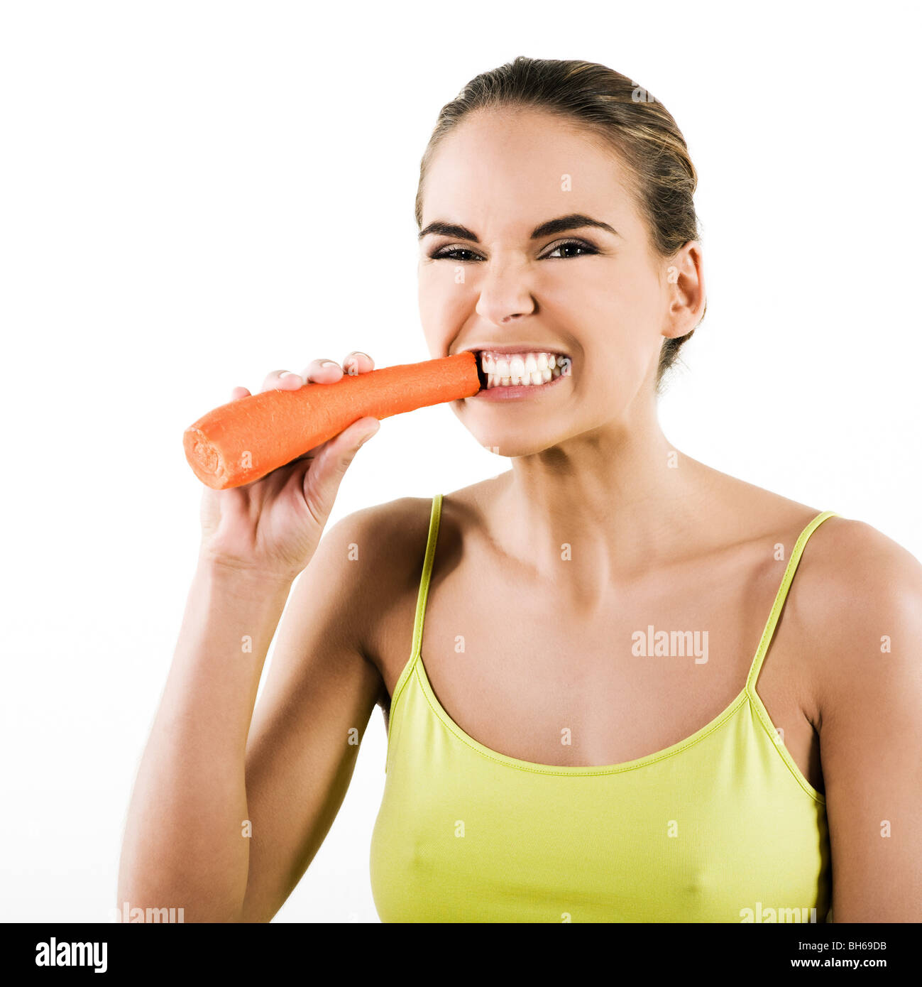 Studio portrait woman eating carrot hi-res stock photography and images ...
