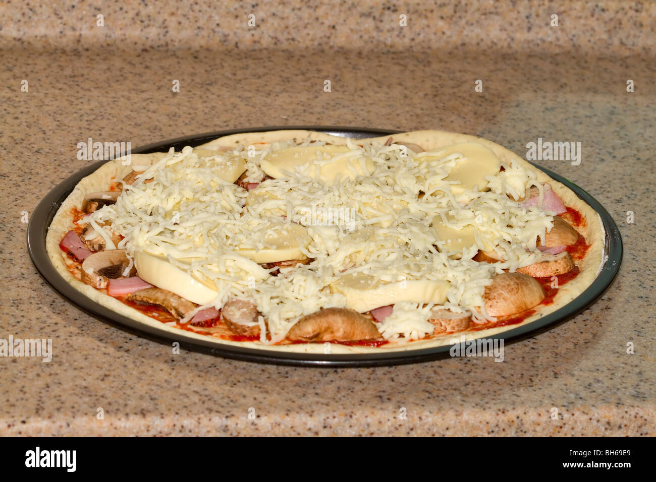 Home made pizza ready for the oven Stock Photo - Alamy