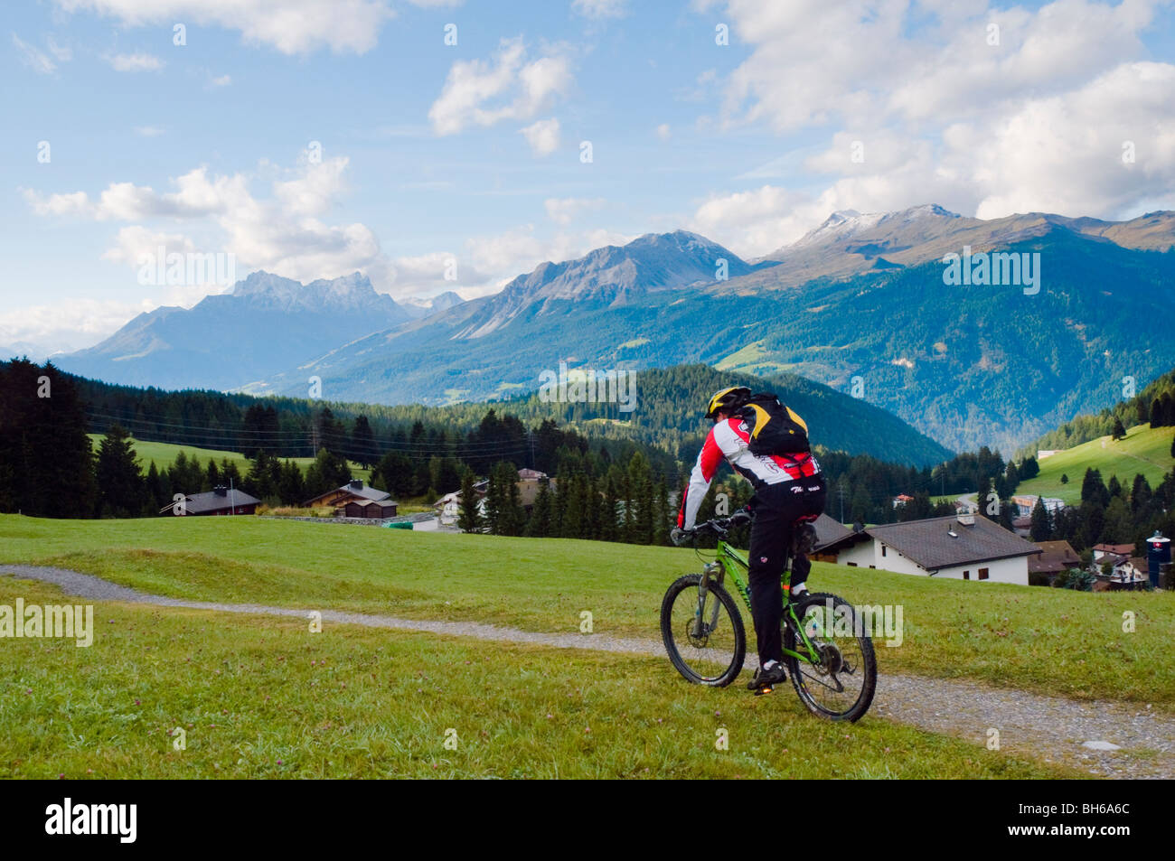 Mountain-biker on an easy Alpine track above Lenzerheide, Graubünden ...