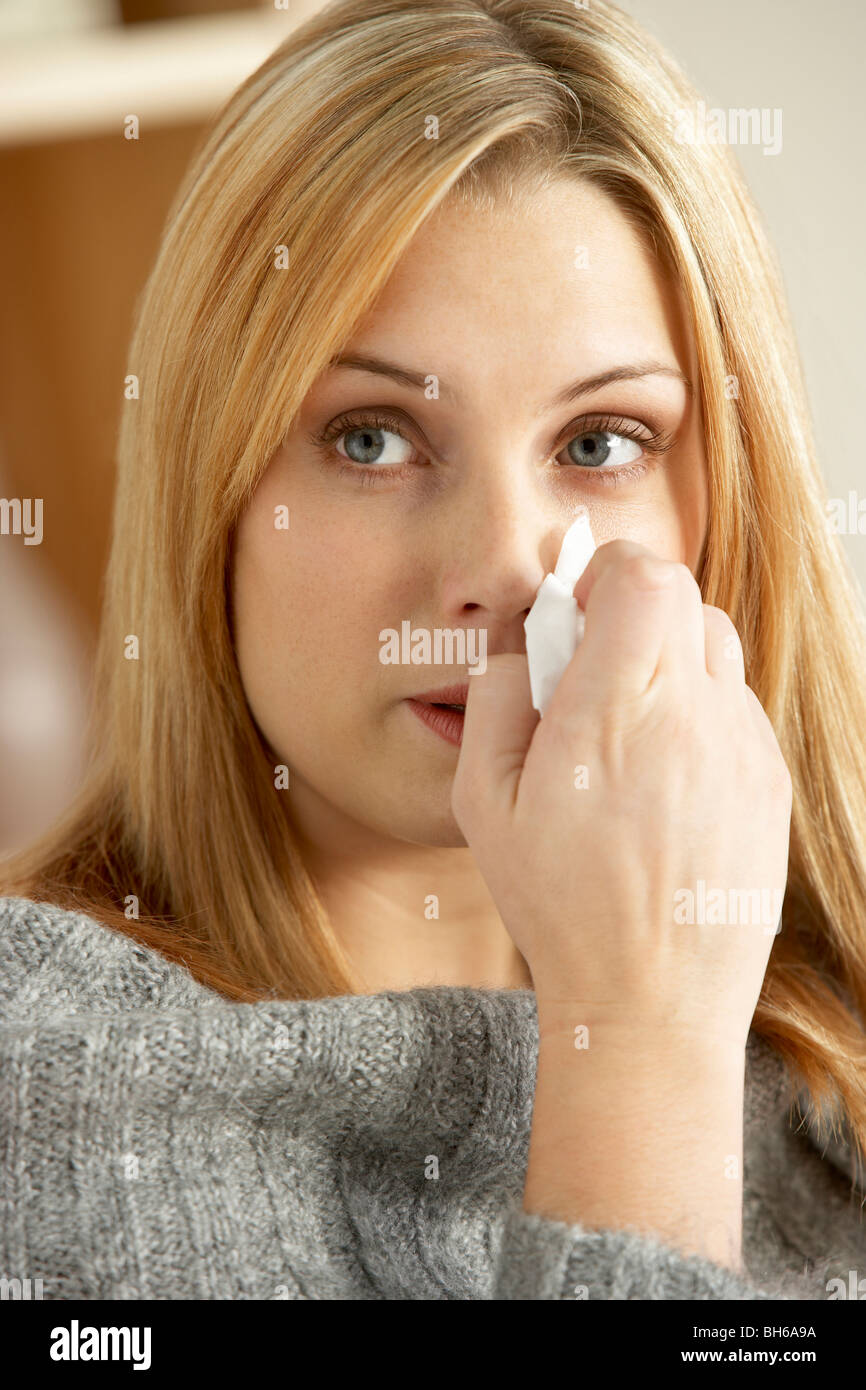 Young Woman With Cold Blowing Nose Stock Photo - Alamy
