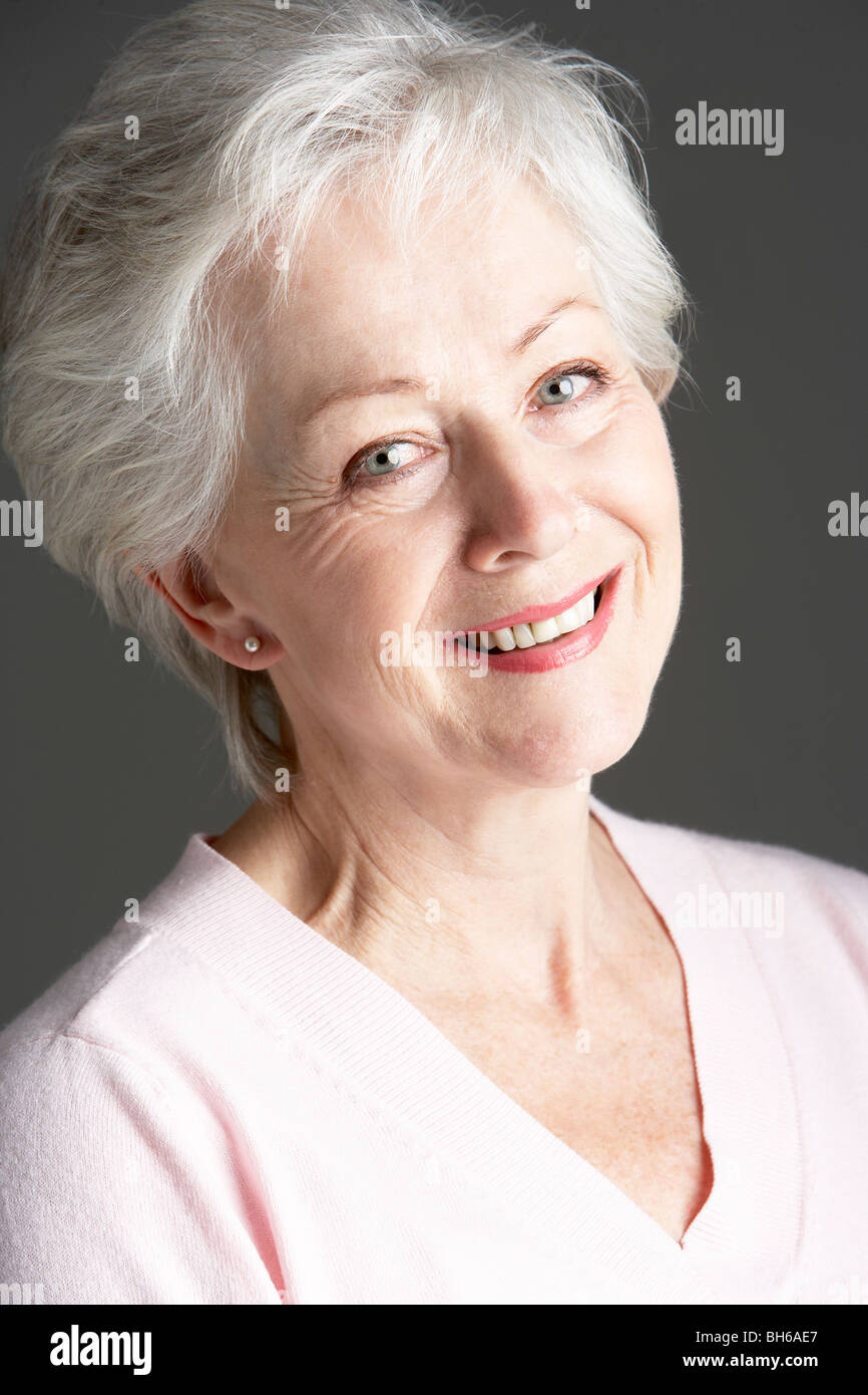 Studio Portrait Of Smiling Senior Woman Stock Photo - Alamy