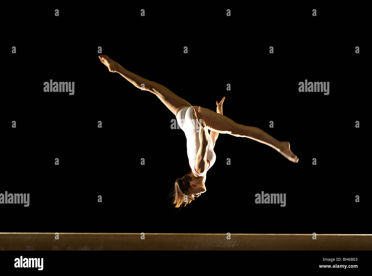 gymnast jumping on beam Stock Photo - Alamy