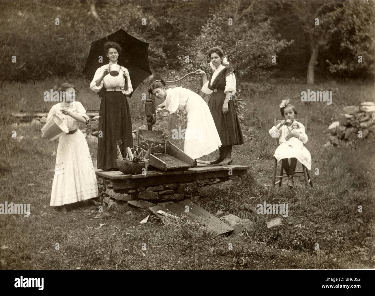 Women Pumping Fresh Water at Outdoor Well Stock Photo - Alamy