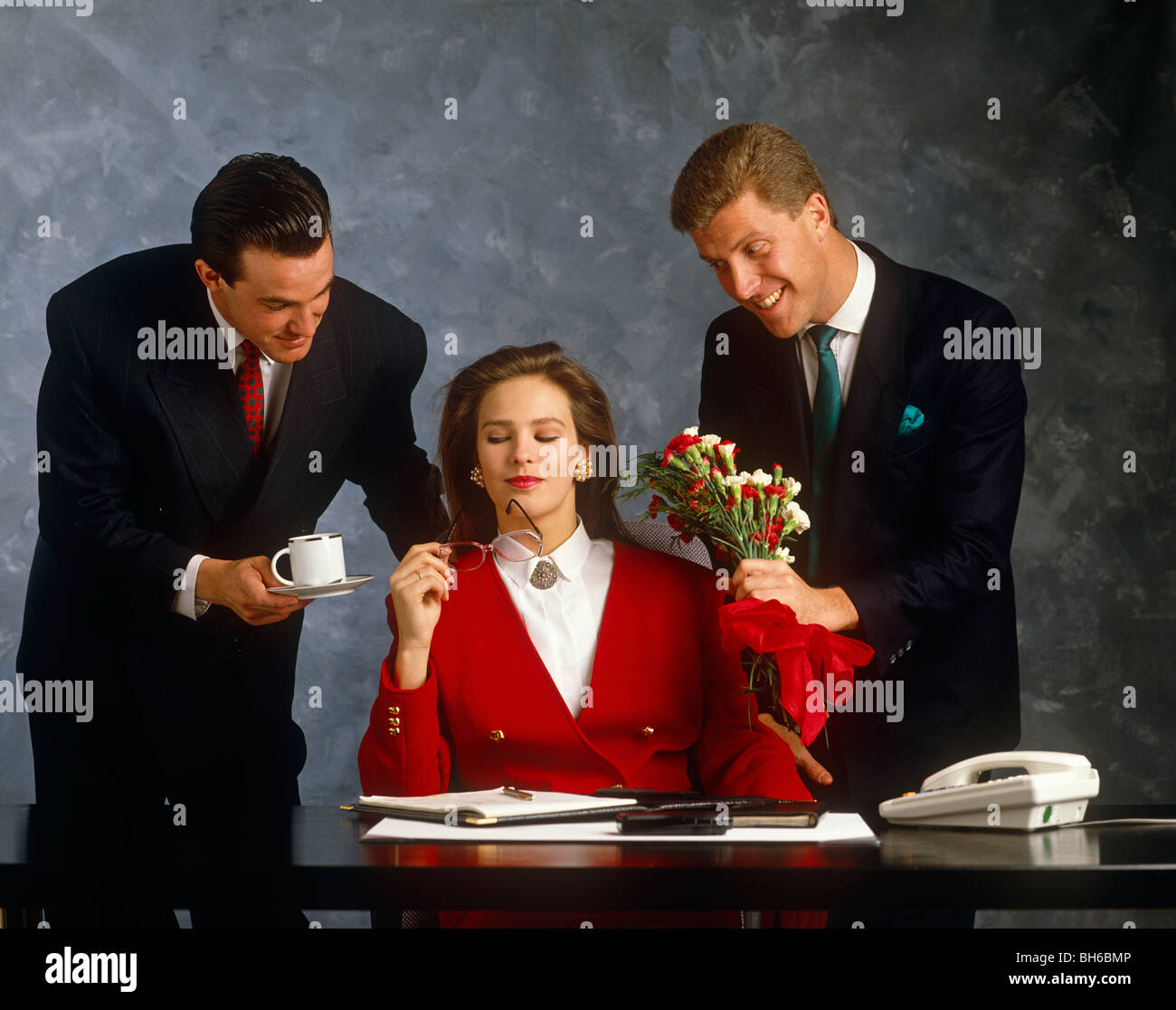 One woman and two men in office situation Stock Photo - Alamy