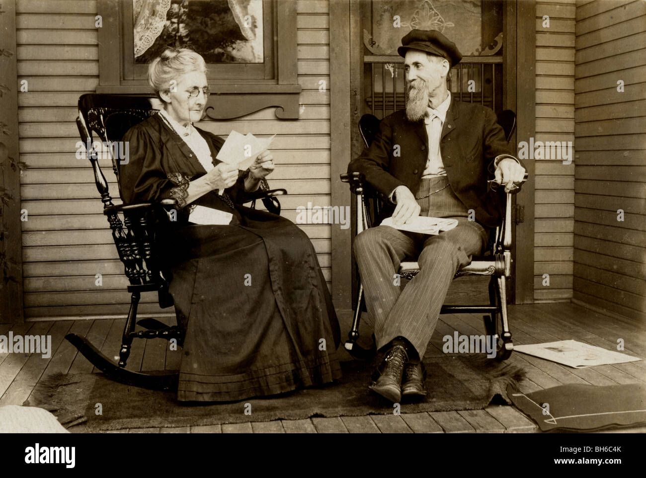 Elderly Couple Reading Mail on the Porch Stock Photo - Alamy