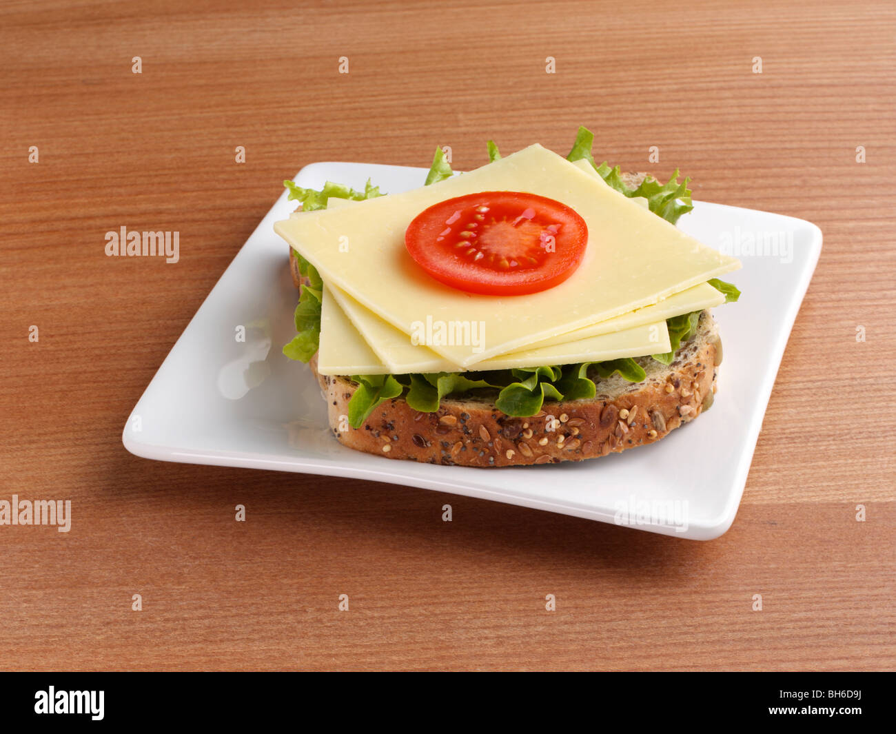 Open cheese sandwich on a white plate Stock Photo - Alamy