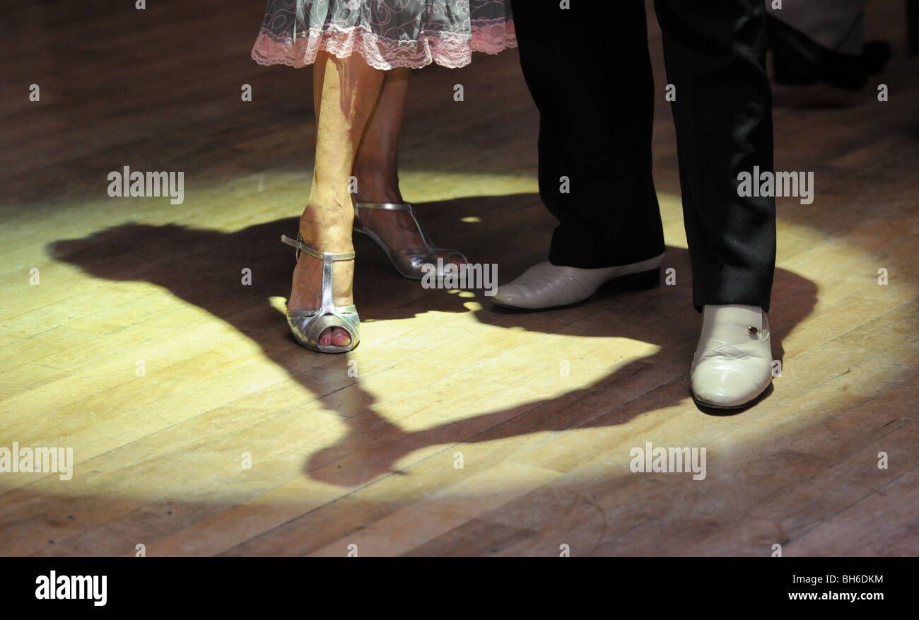 Older couple at a tea dance, ballroom dance floor shadow of man and ...
