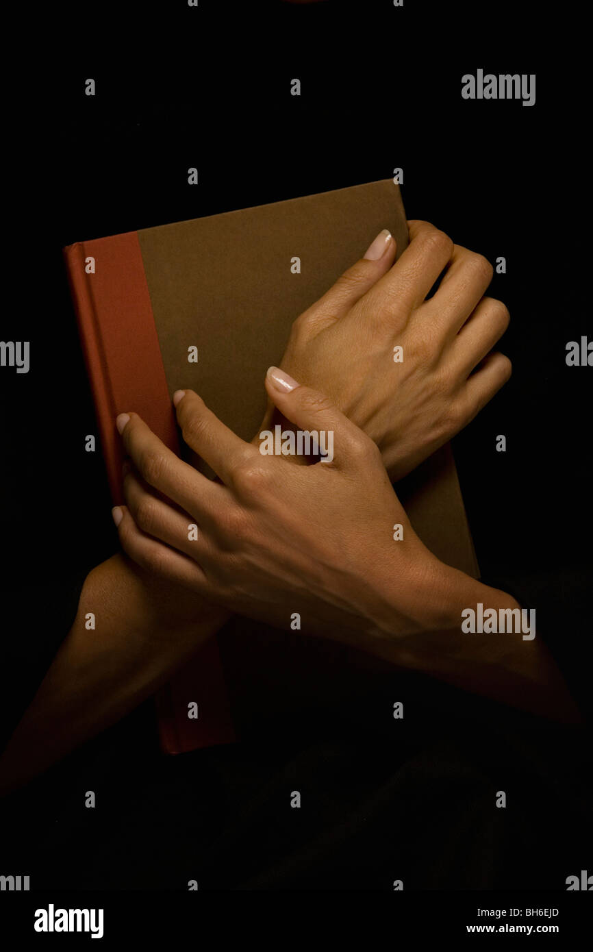 Hands holding book hi-res stock photography and images - Alamy
