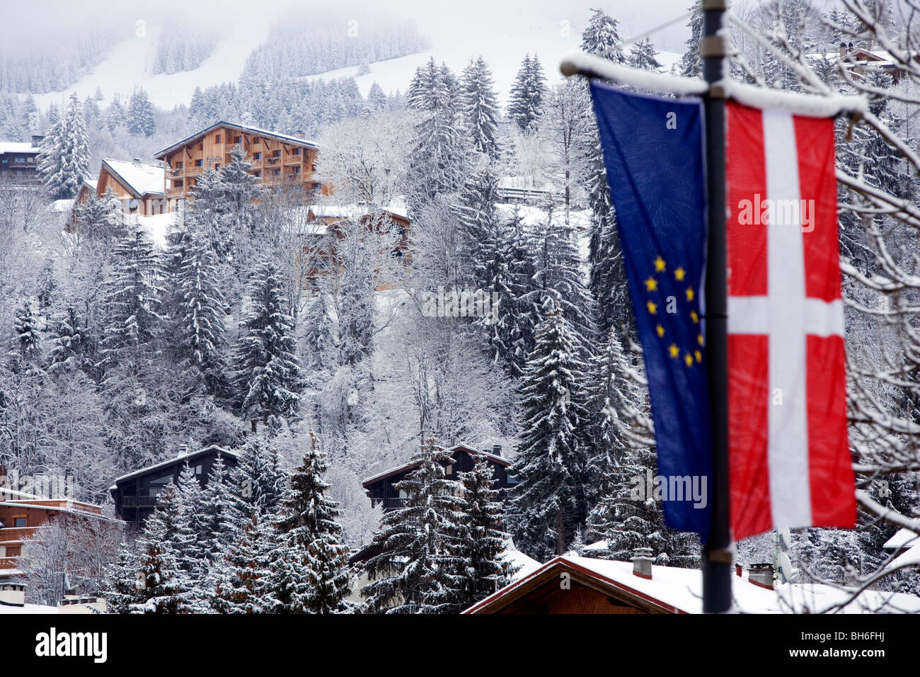 Snow scene. Chalets, firs, flags. Megève, Haute Savoie, France, Europe ...
