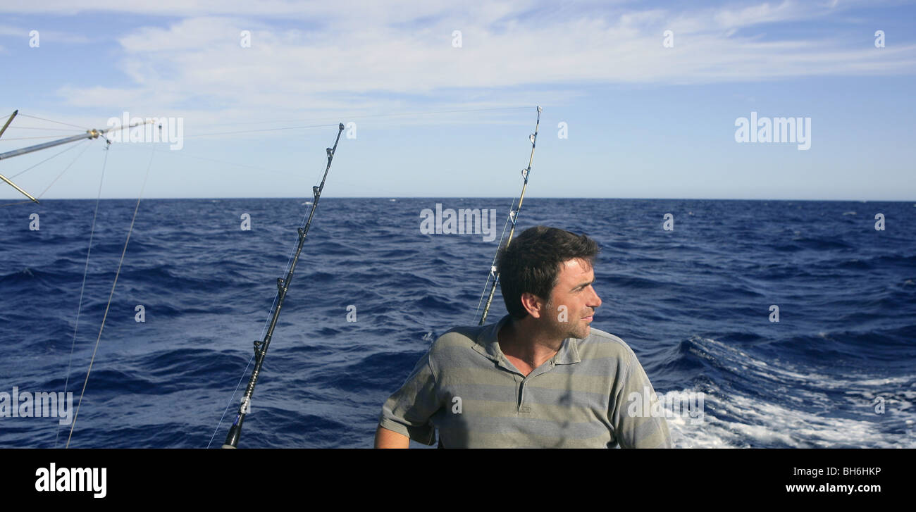 Angler big game saltwater fisher boat with rods and reels Stock Photo ...