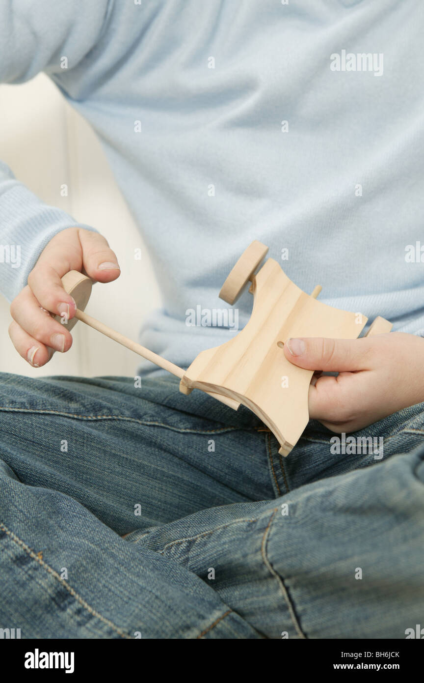 Childrens hand constructing wooden toys Stock Photo - Alamy