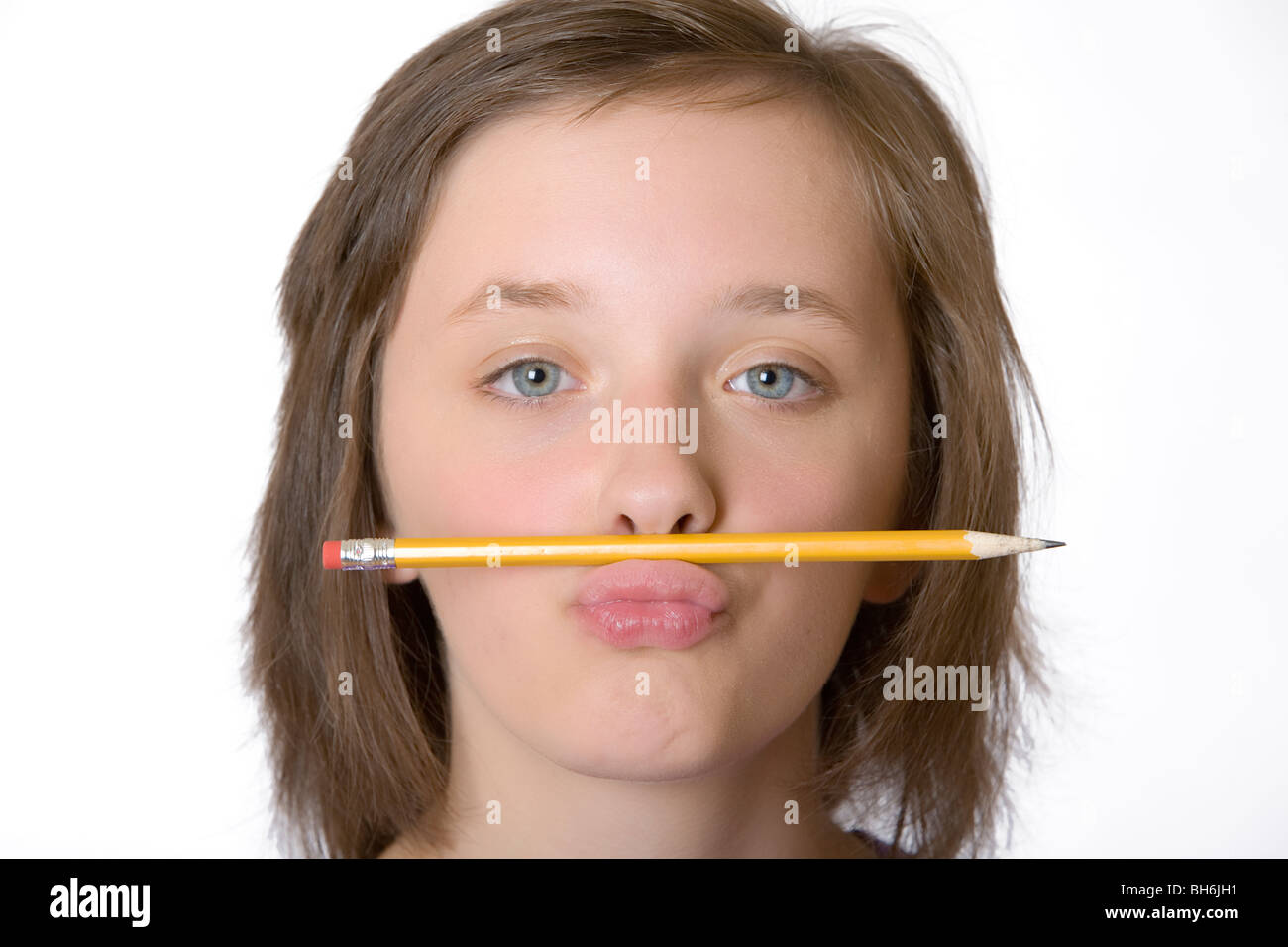 Girl holding pencil between lips hi-res stock photography and images ...