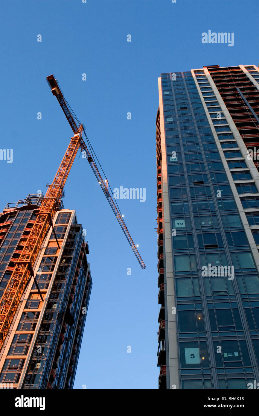 Modern high-rise building during construction at sunset in perspective ...