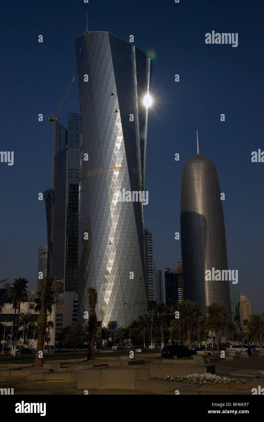 Portrait view of Doha modern skyscrapers with sun glinting from the ...