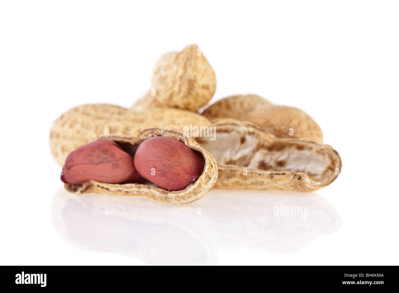 peanuts cracked open isolated on a white background Stock Photo - Alamy
