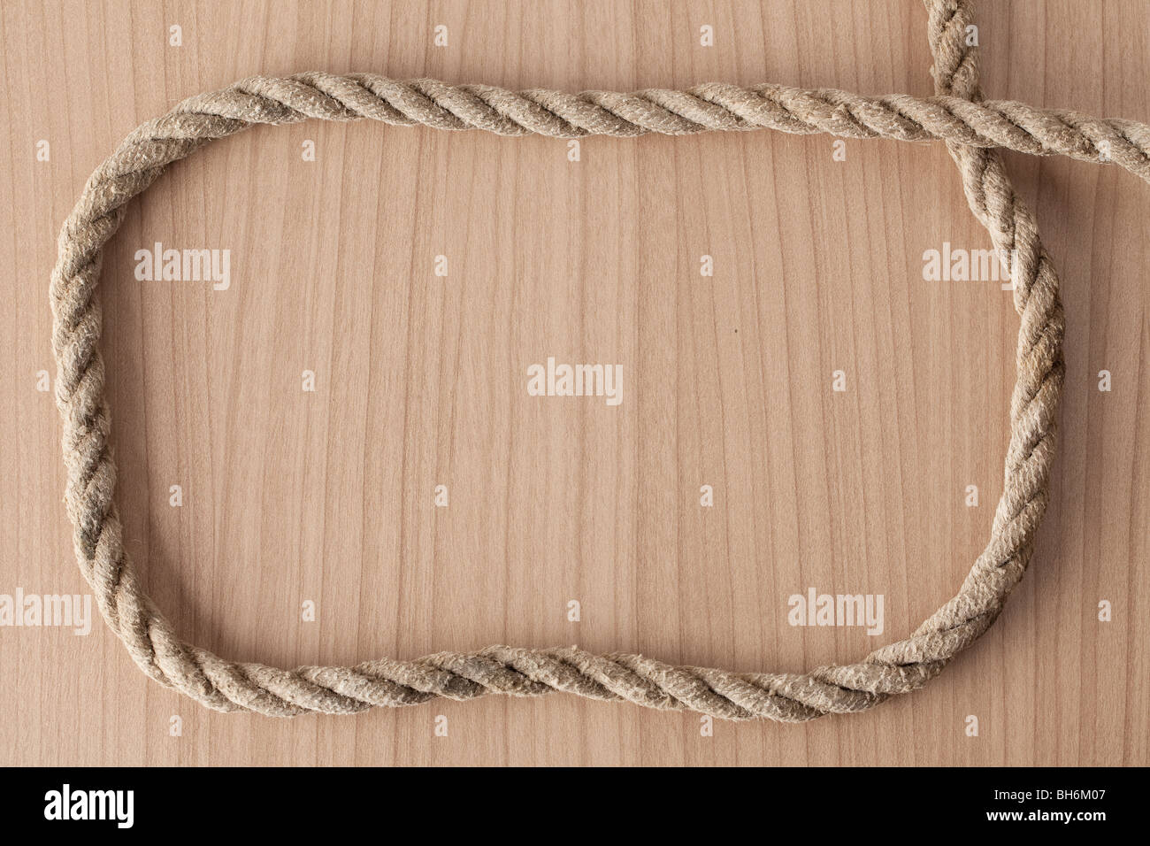 frame make from rope on wooden background Stock Photo - Alamy