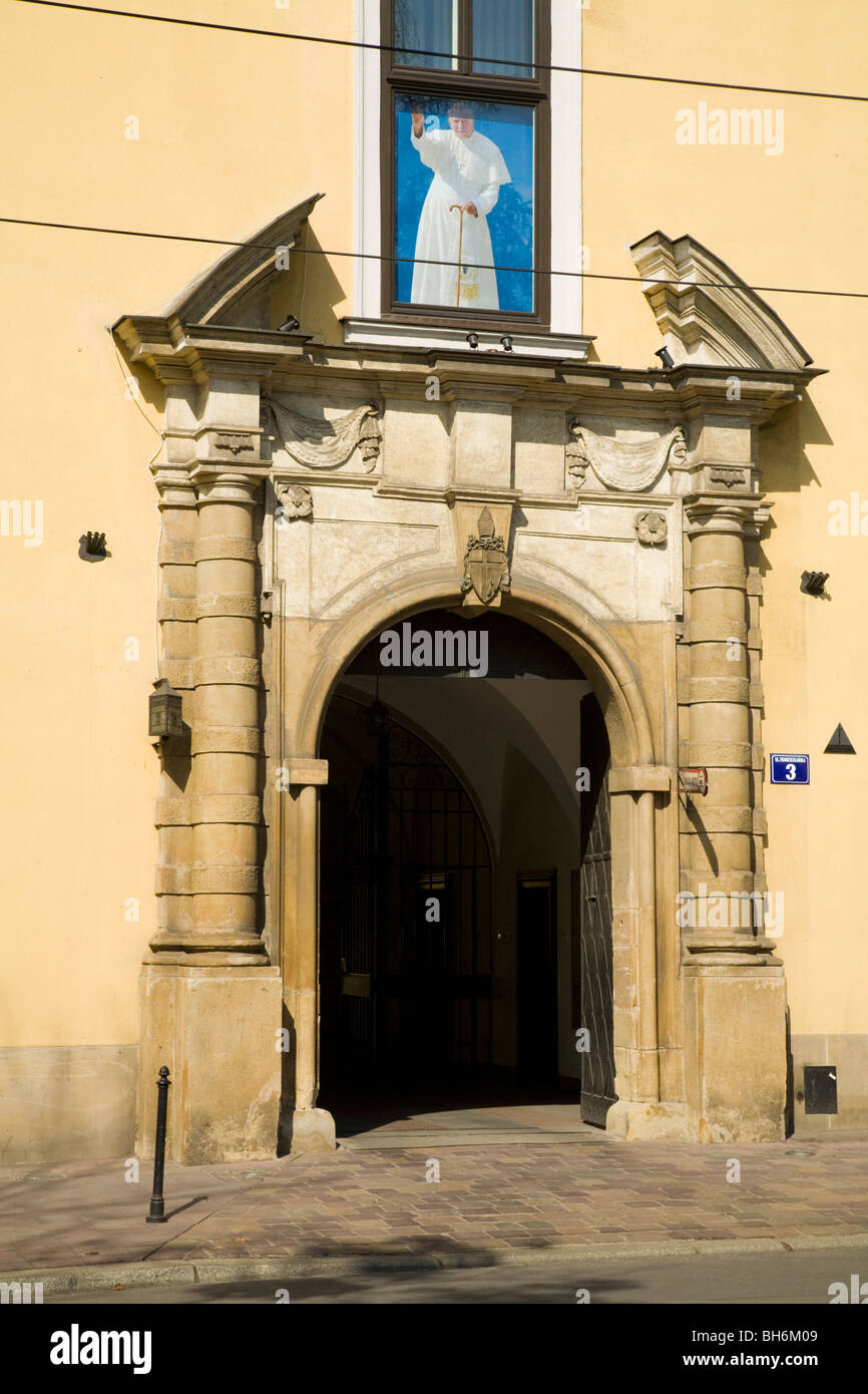 Photographic image of Pope John - Paul II on display in a window above ...