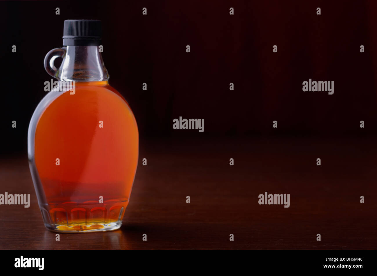 A bottle of maple syrup sits on a table Stock Photo - Alamy