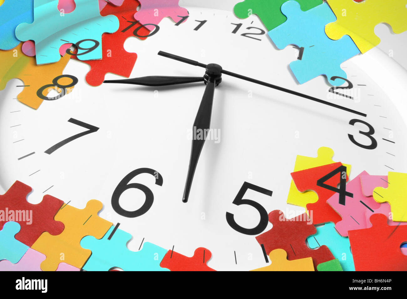 Clock and Jigsaw Puzzle Pieces Stock Photo - Alamy