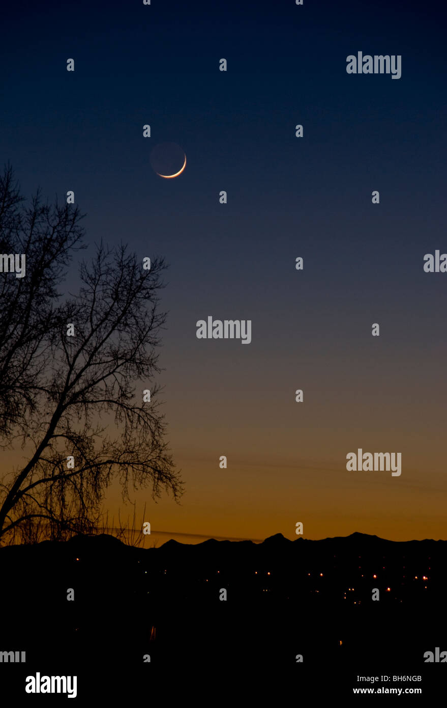 Crescent moon over mountains Stock Photo - Alamy