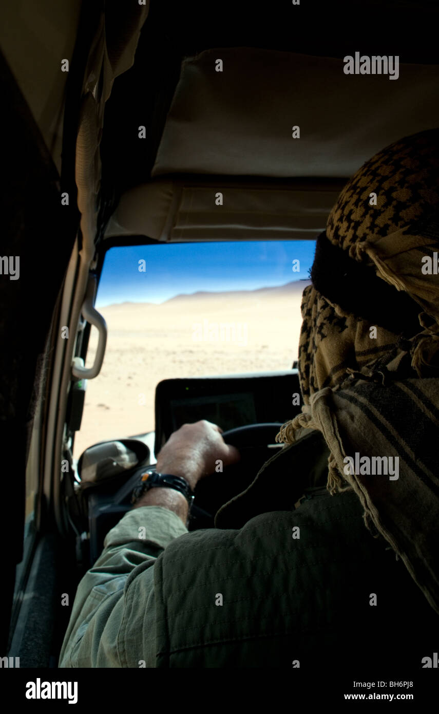 An Egyptian desert safari guide drives an off-road 4x4 land cruiser ...