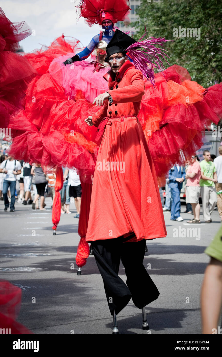 A costumed live mannequin moves around on stilts at the Just for Laughs ...
