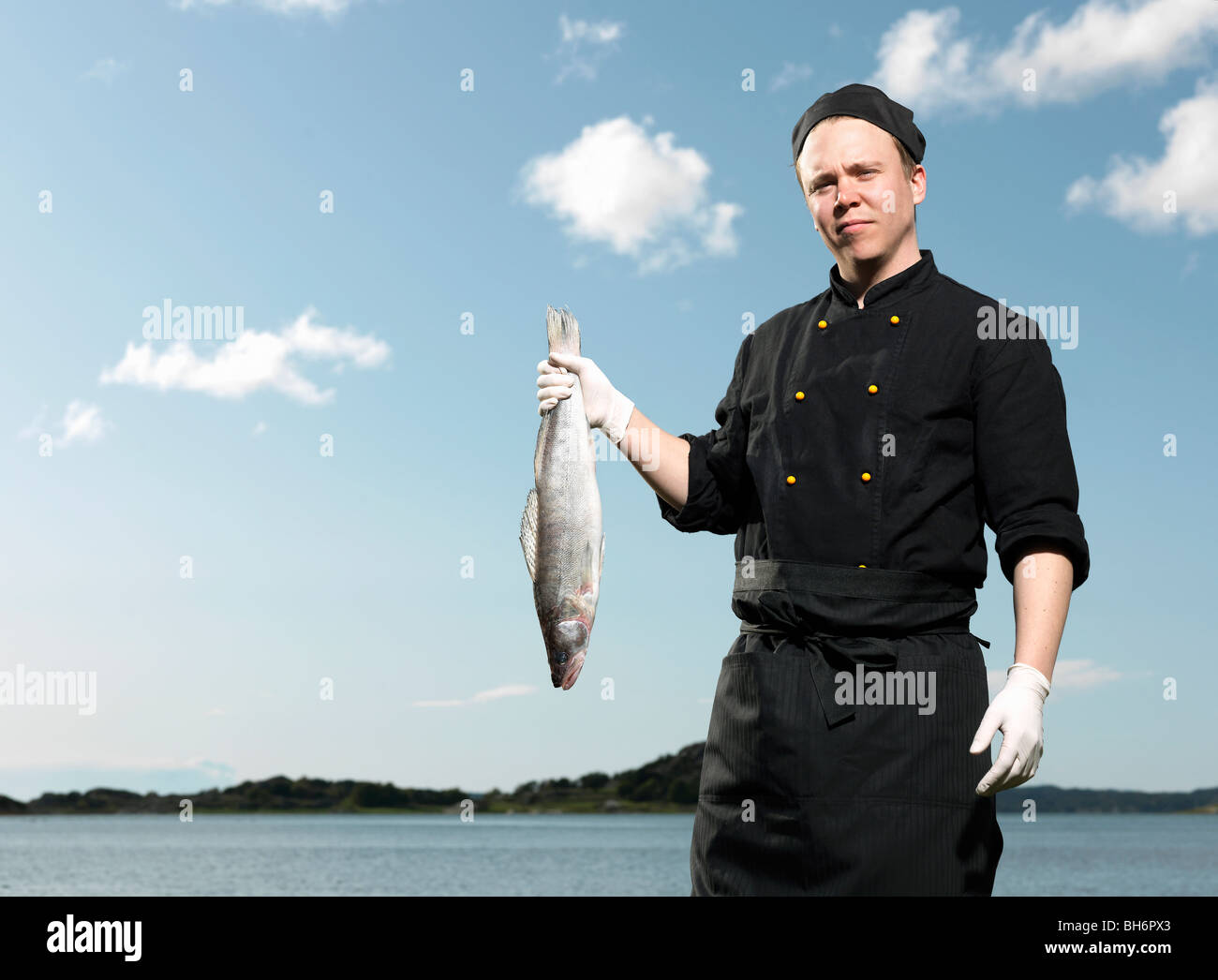 Chef holding fish Stock Photo - Alamy
