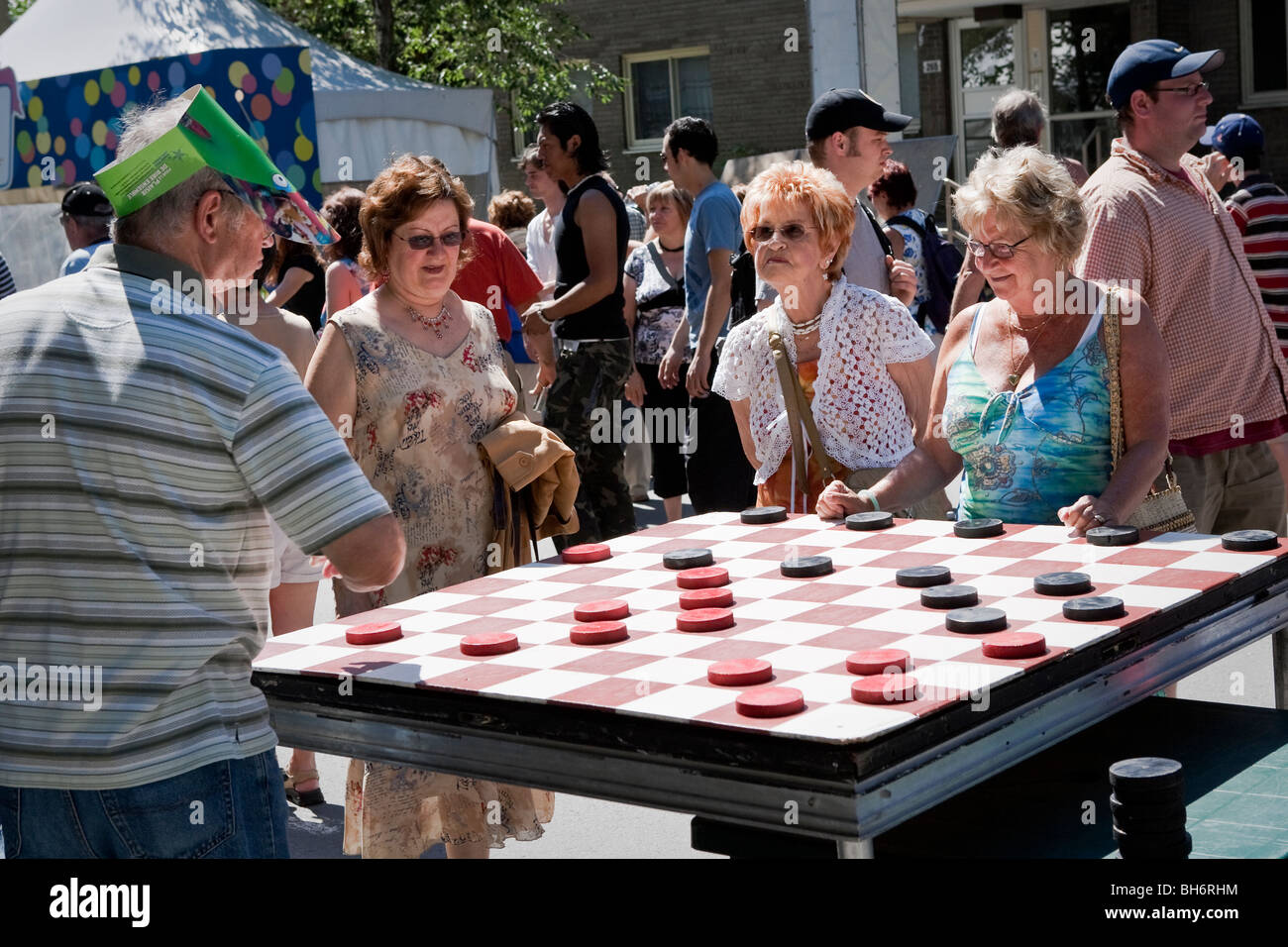 Elderly couples play checkers on a giant board at the Just for laughs ...