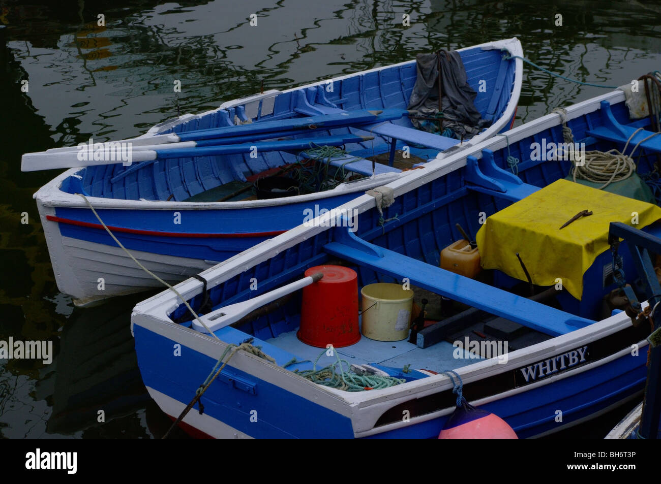 2 blue boats in the harbour in Whitby Stock Photo - Alamy