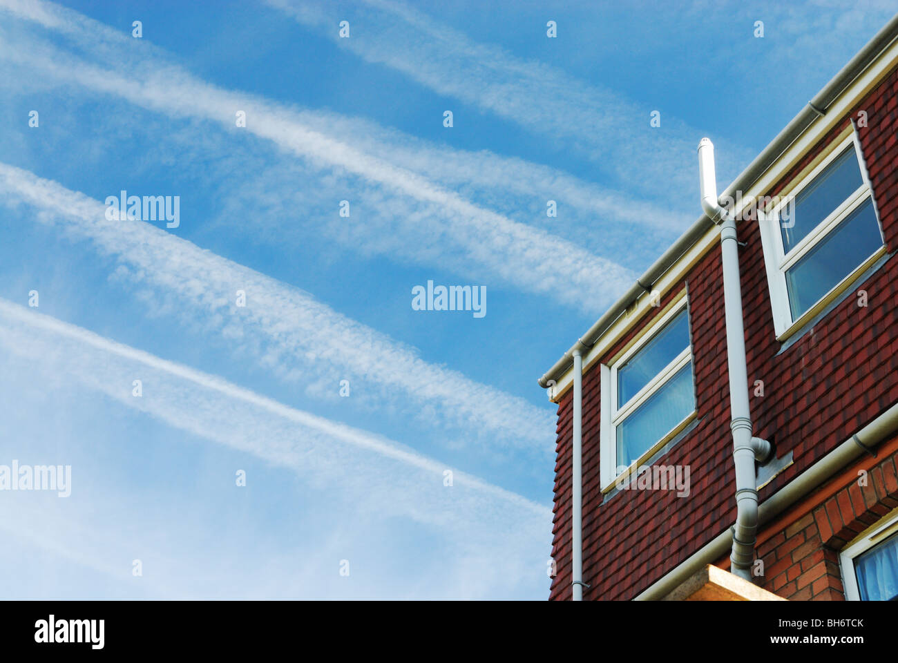 High altitude jet aircraft contrails filling the sky on a typical ...