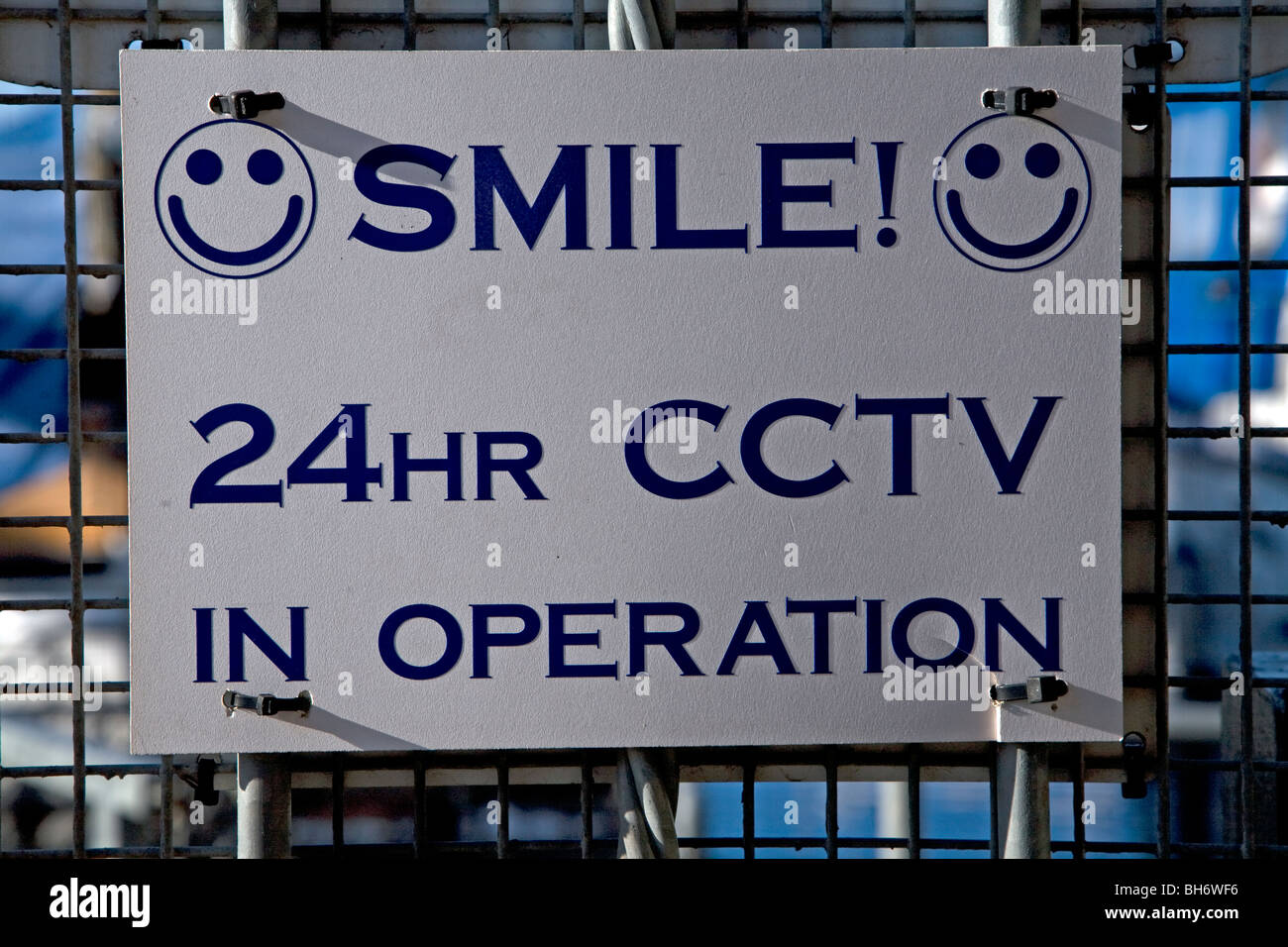 Smile 24 hour CCTV sign in operation Stock Photo - Alamy