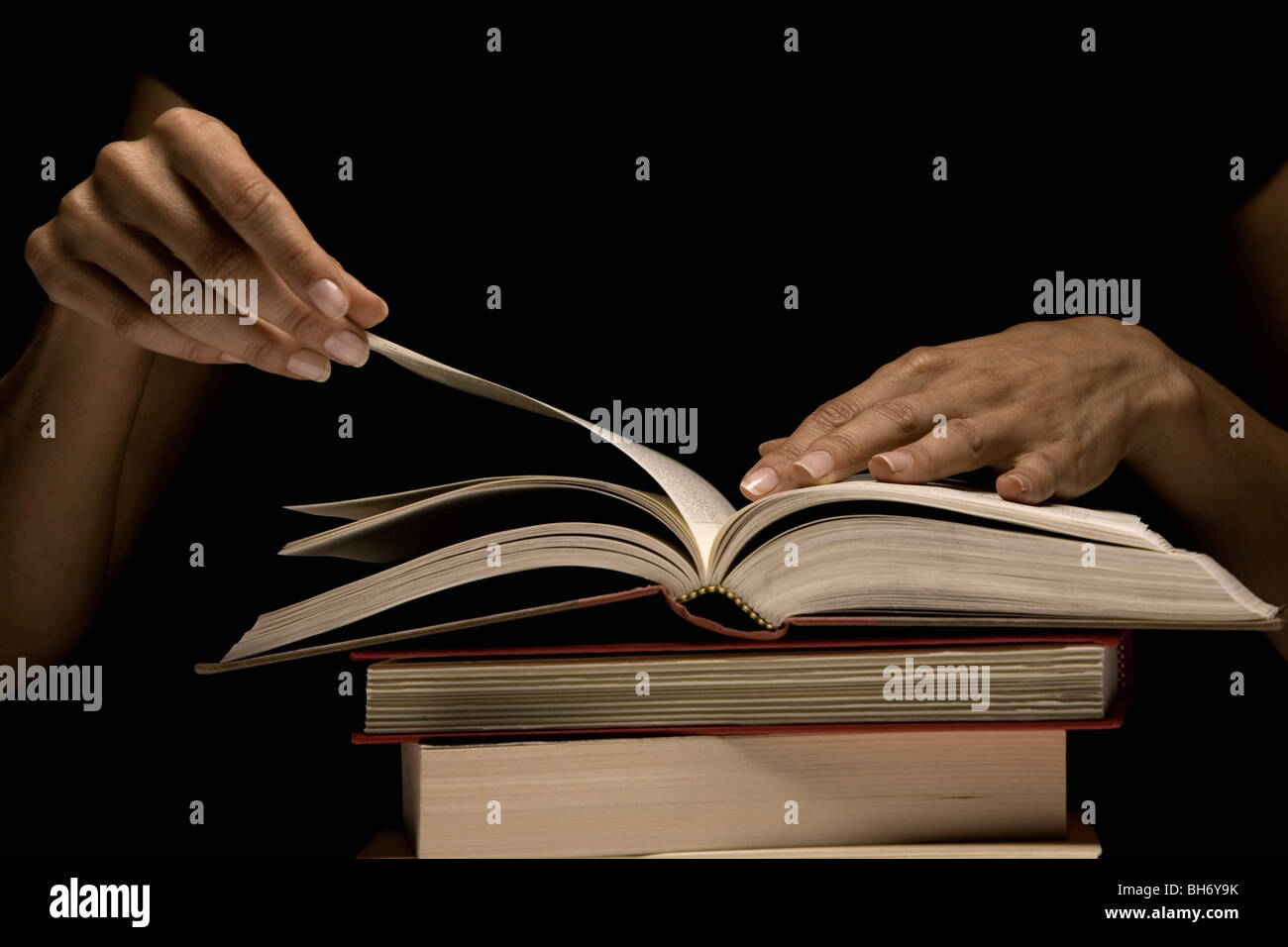 Hands turning book page Stock Photo - Alamy