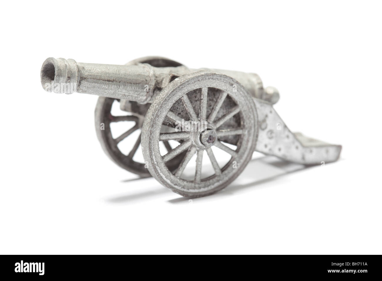 Old metallic toy cannon isolated on white Stock Photo - Alamy
