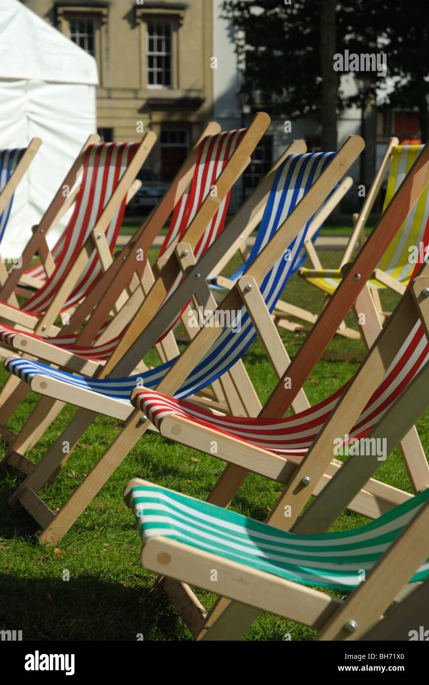Deckchairs set out in a city park ready for a summer event performance ...
