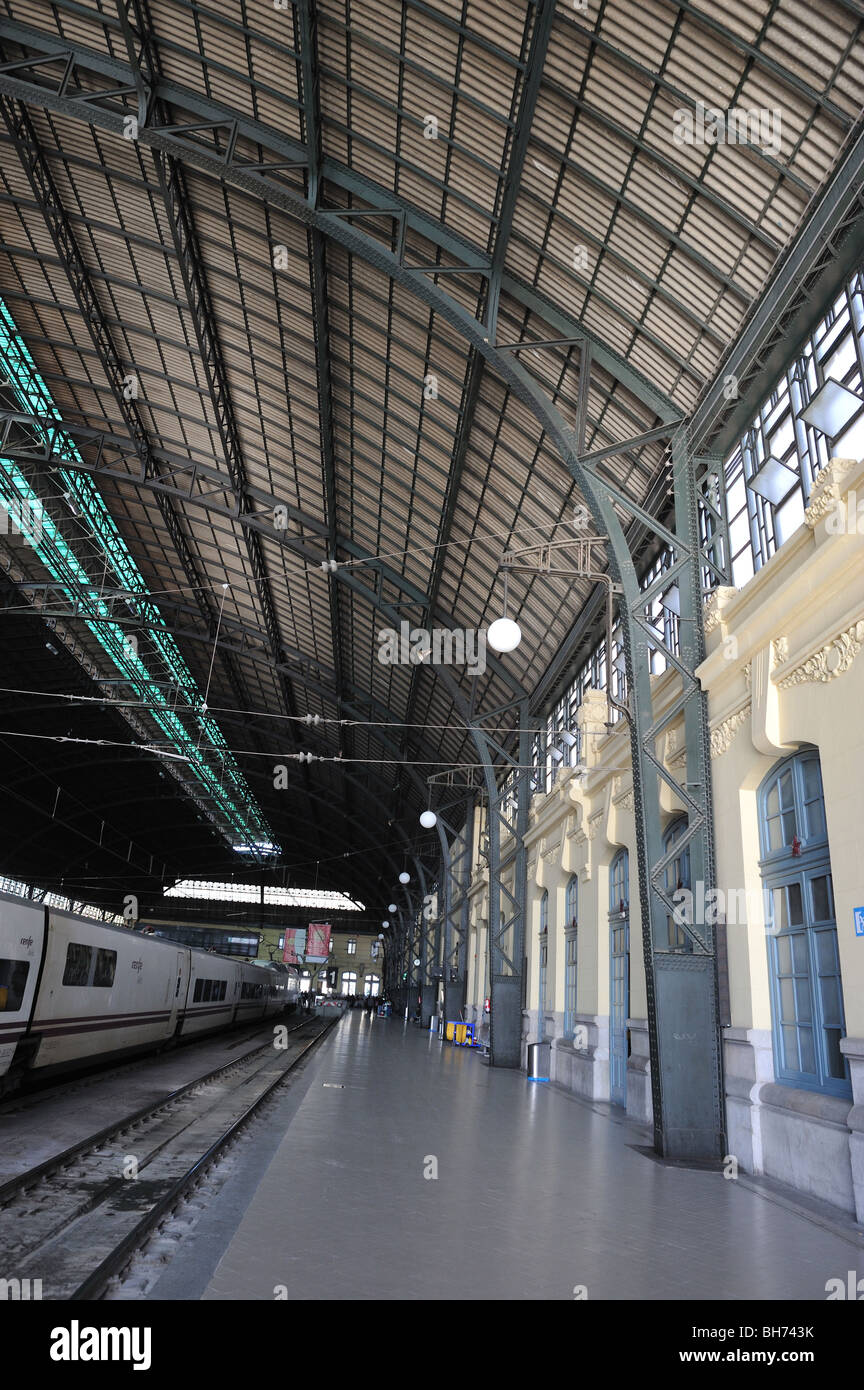Interior of railway station with stopped train and empty platform ...