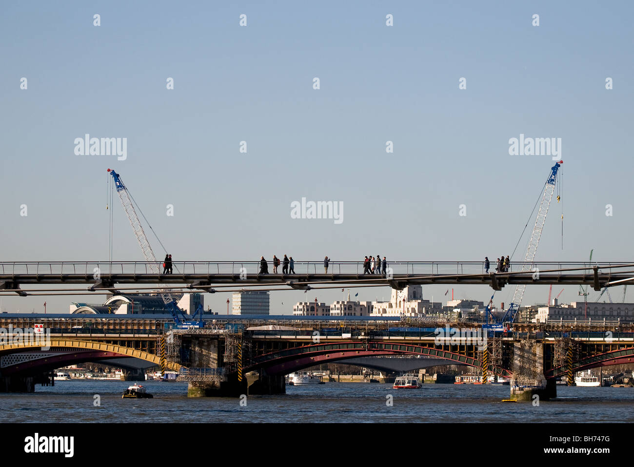 People crossing over the Millenium Bridge in London. Photo by Gordon ...