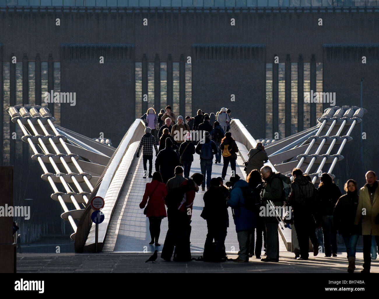 People crossing over the Millenium Bridge in London. Photo by Gordon ...