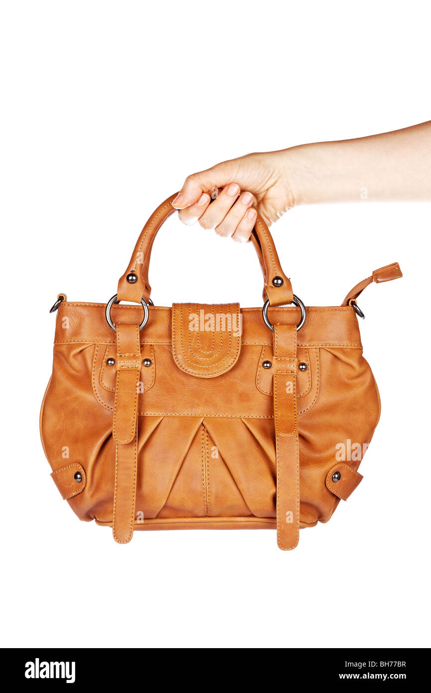 Holding a brown handbag isolated on white background Stock Photo - Alamy