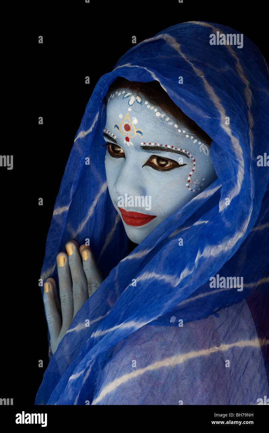 Indian girl, face painted as the Hindu goddess Sita wearing a blue ...