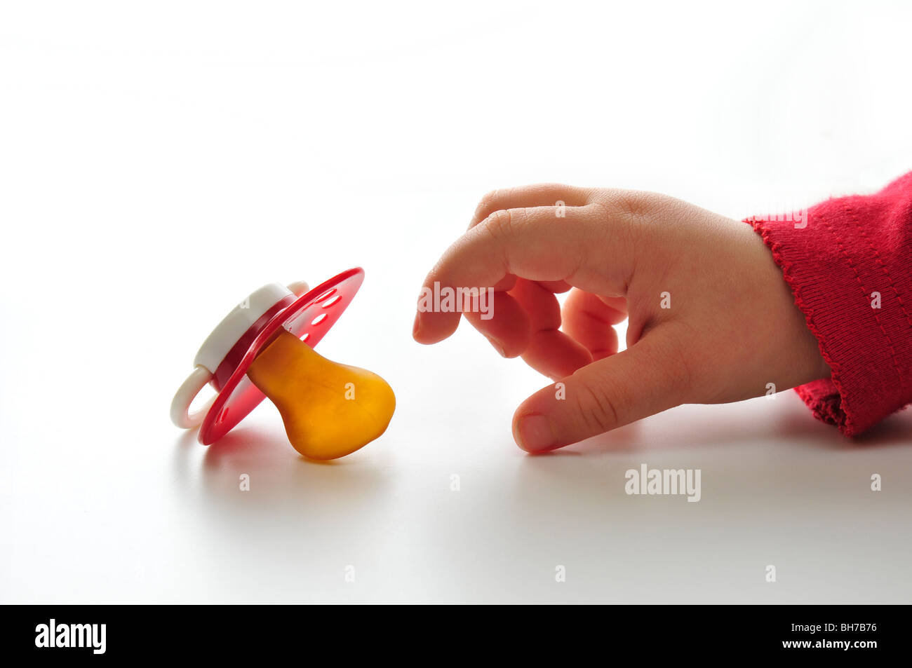 Children's dummy. Child taking the pacifier Stock Photo - Alamy