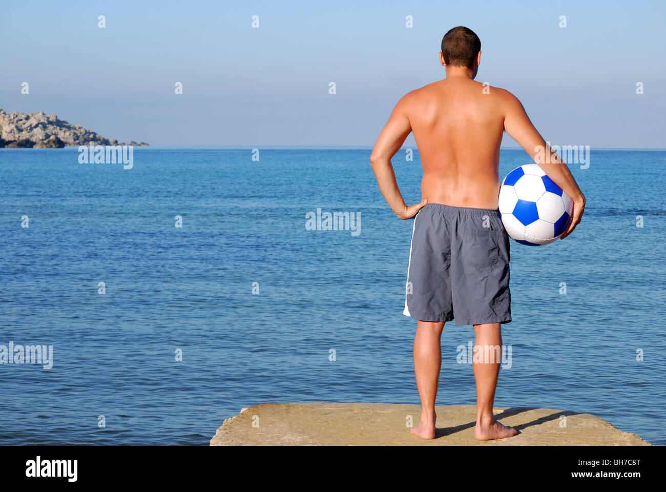 Man looking out to sea Stock Photo - Alamy