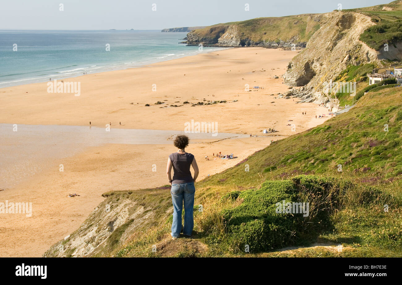 Woman on cliff looking at the beach, coast, Watergate Bay, Cornwall ...