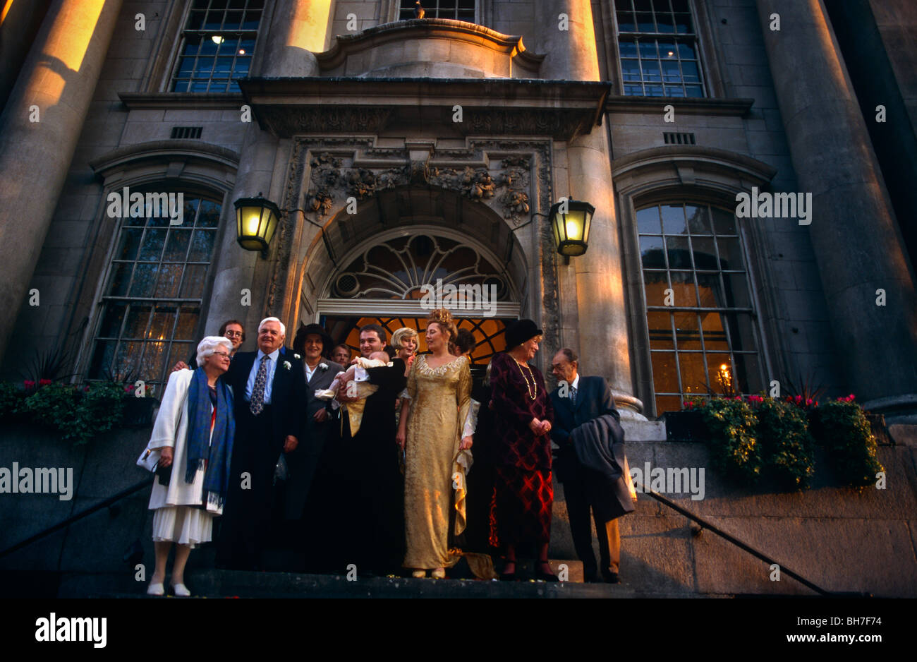 Relatives and friends stand on the steps of the Chelsea registry office ...